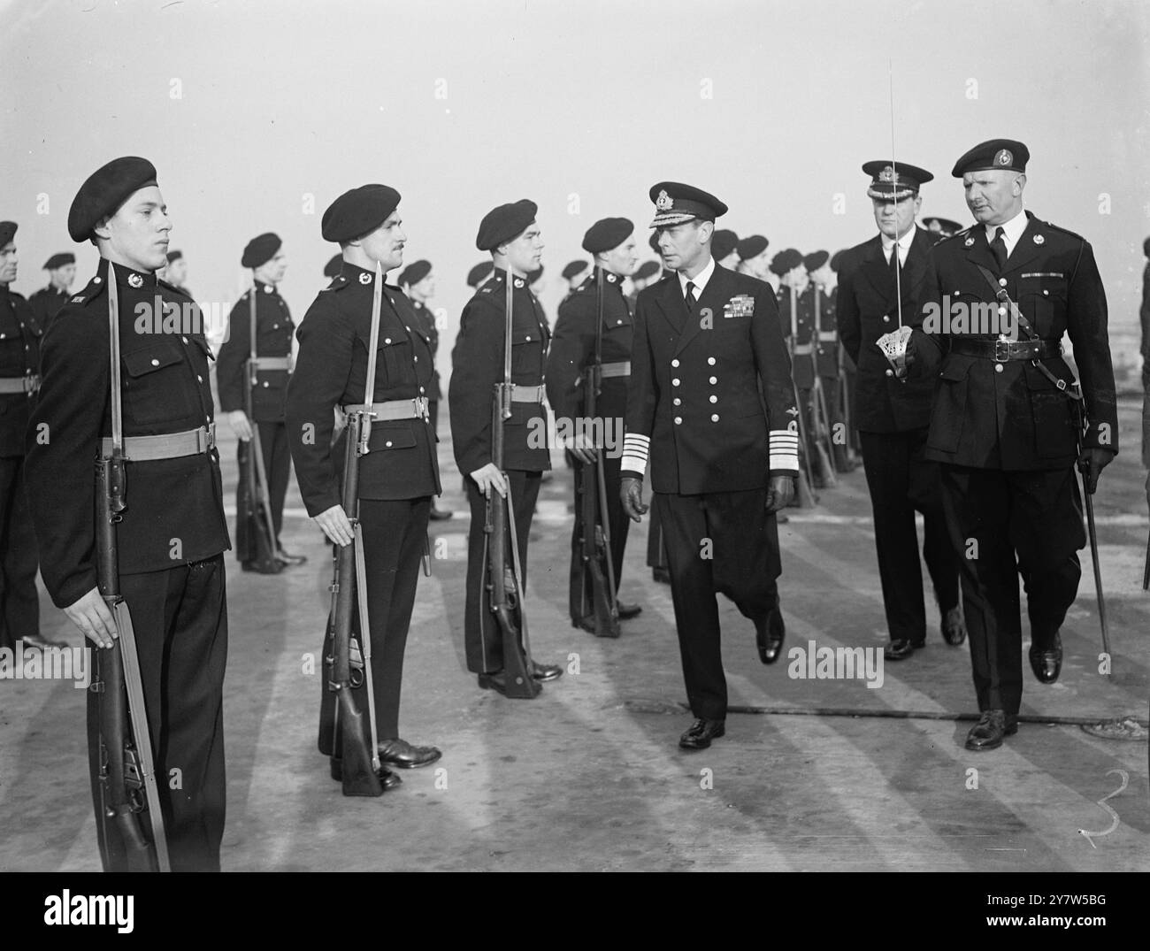 King George VI inspecting Royal Marine gunners on flight deck of HM ...