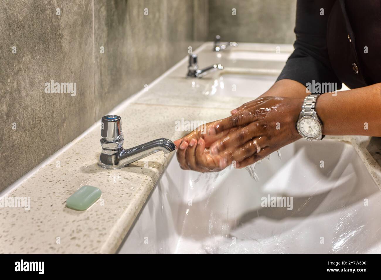 person washing hands at the lavatory, african american man hands in ...