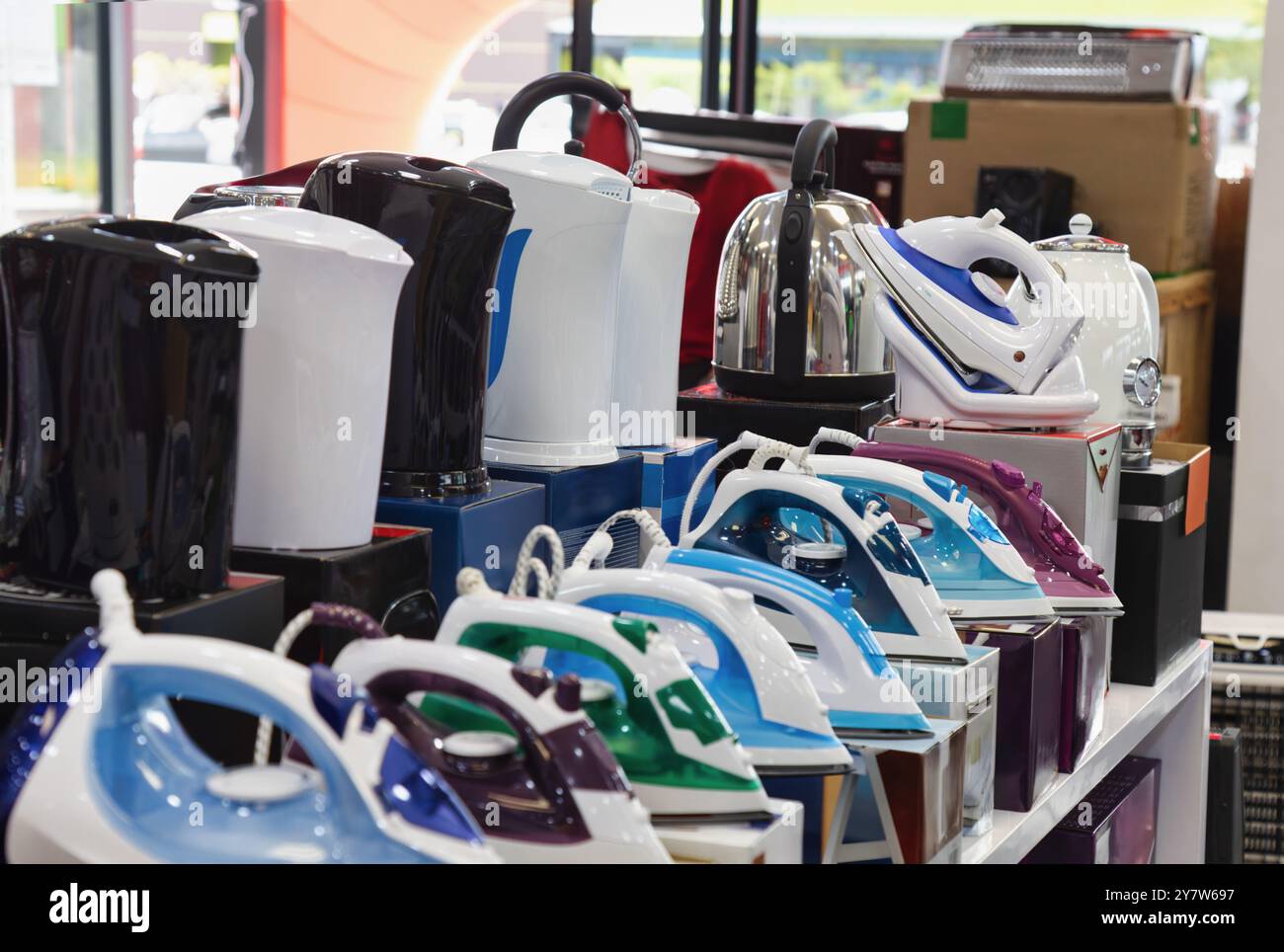 kettle and iron for sale on the shelves of a general appliance store ...