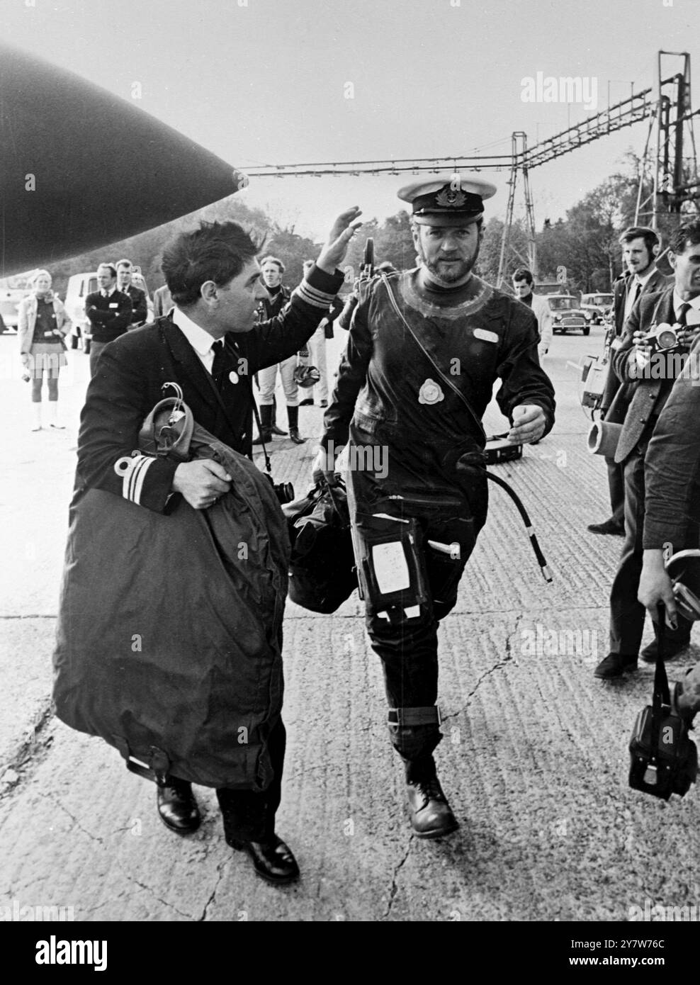 Royal Navy pilot Lt Commander Brian Davies (with cap) leaves his ...