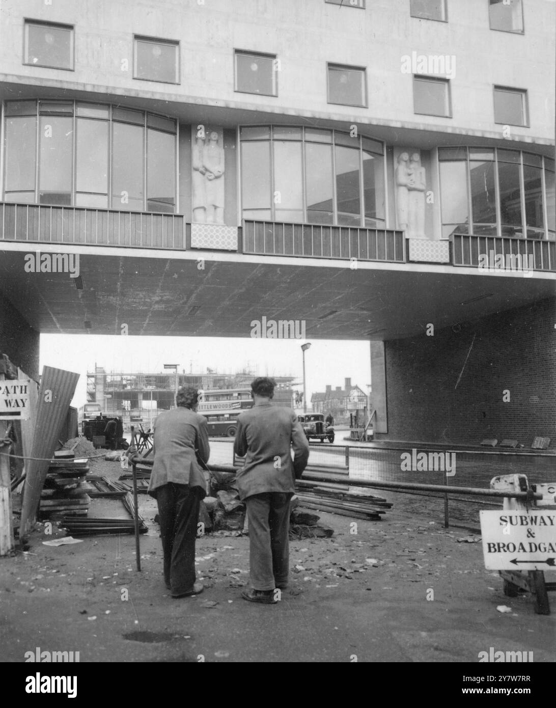 Building Beauty from Chaos in CoventryTwo men look under the arch of ...