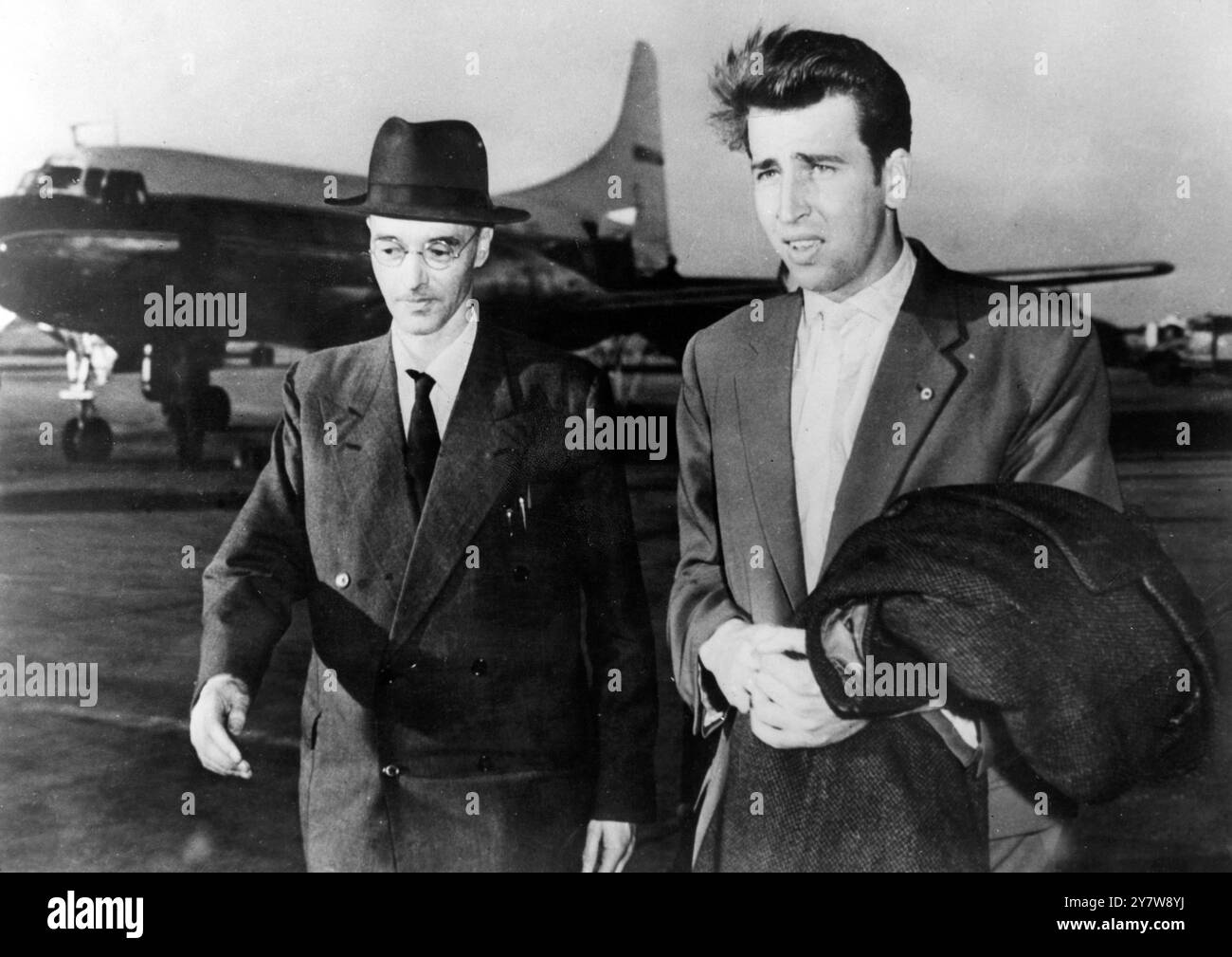 Atom spy Dr Klaus Fuchs wearing glasses, arrives at East Berlin Airport ...