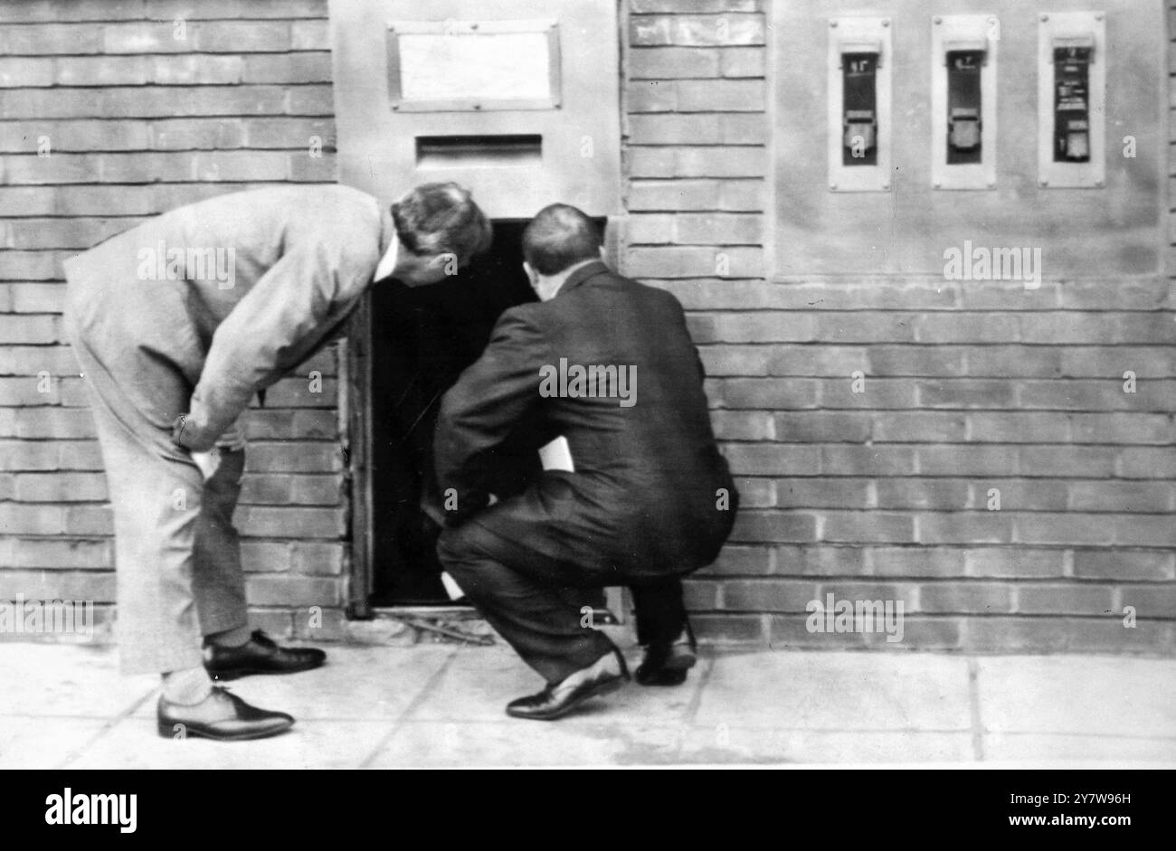 Plain clothes detectives take a close look at the post box, where a ...
