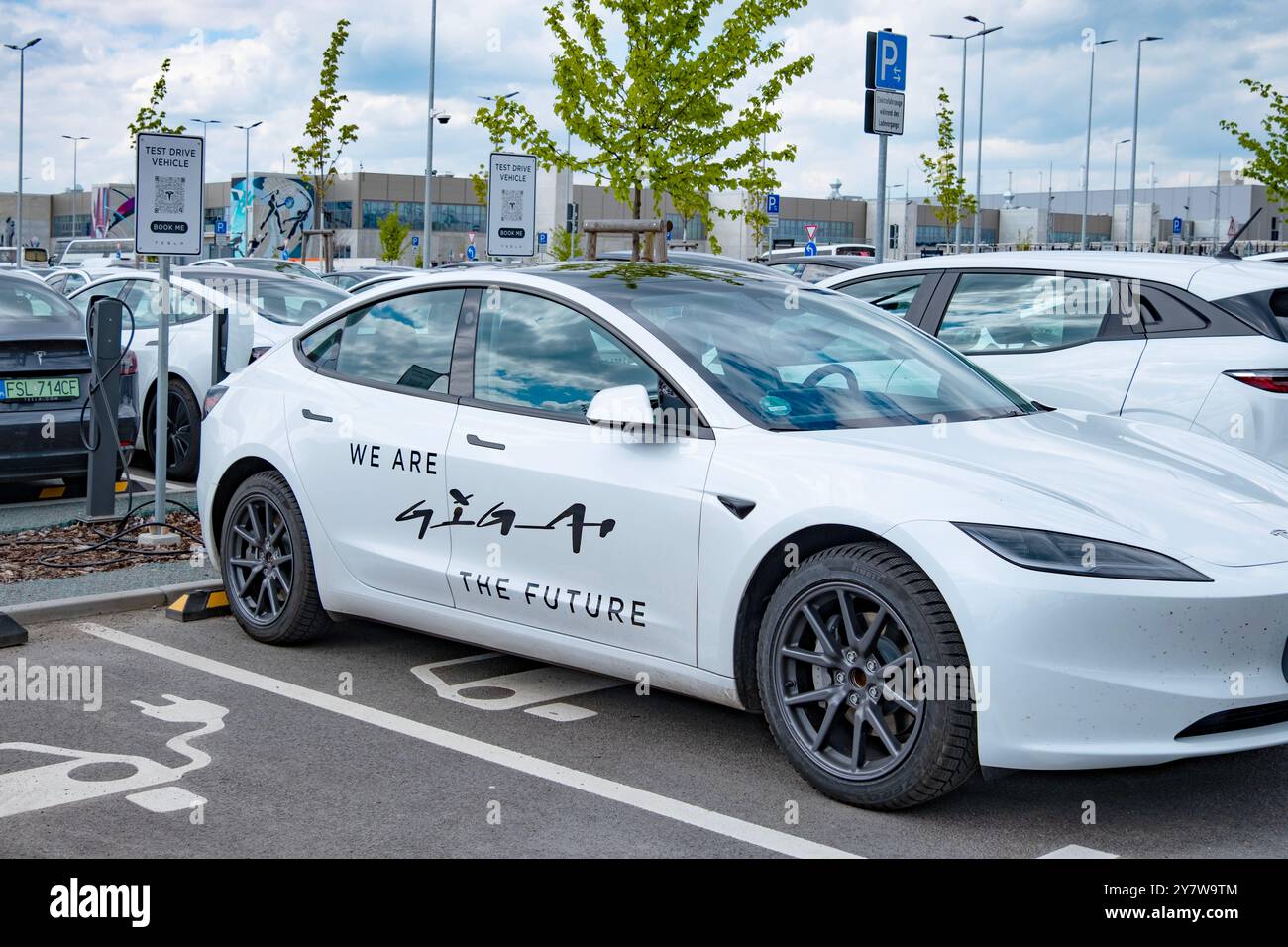 Tesla model y electric car on Free charging station, Tesla-Supercharger ...