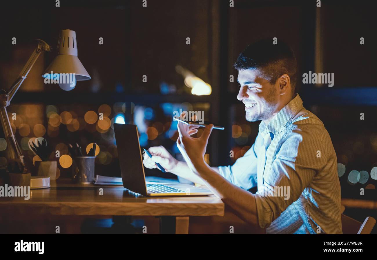 Smiling Businessman Using Voice Assistant In Modern Office At Night ...