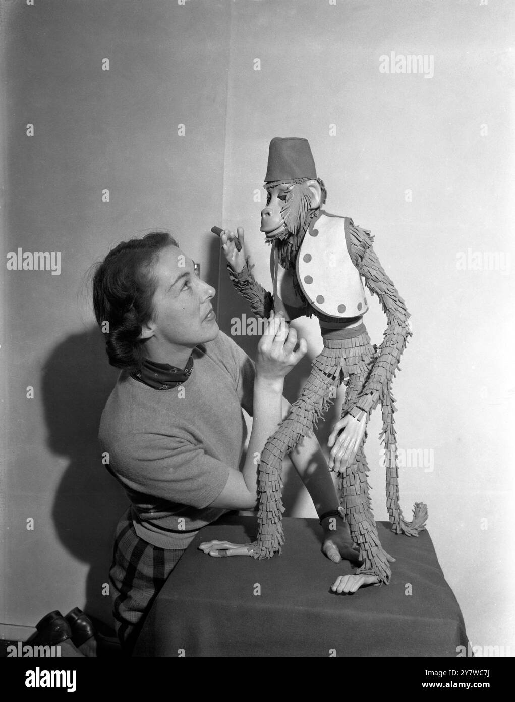 A cheeky looking monkey gets the finishing touches from Miss Ann Popham ...