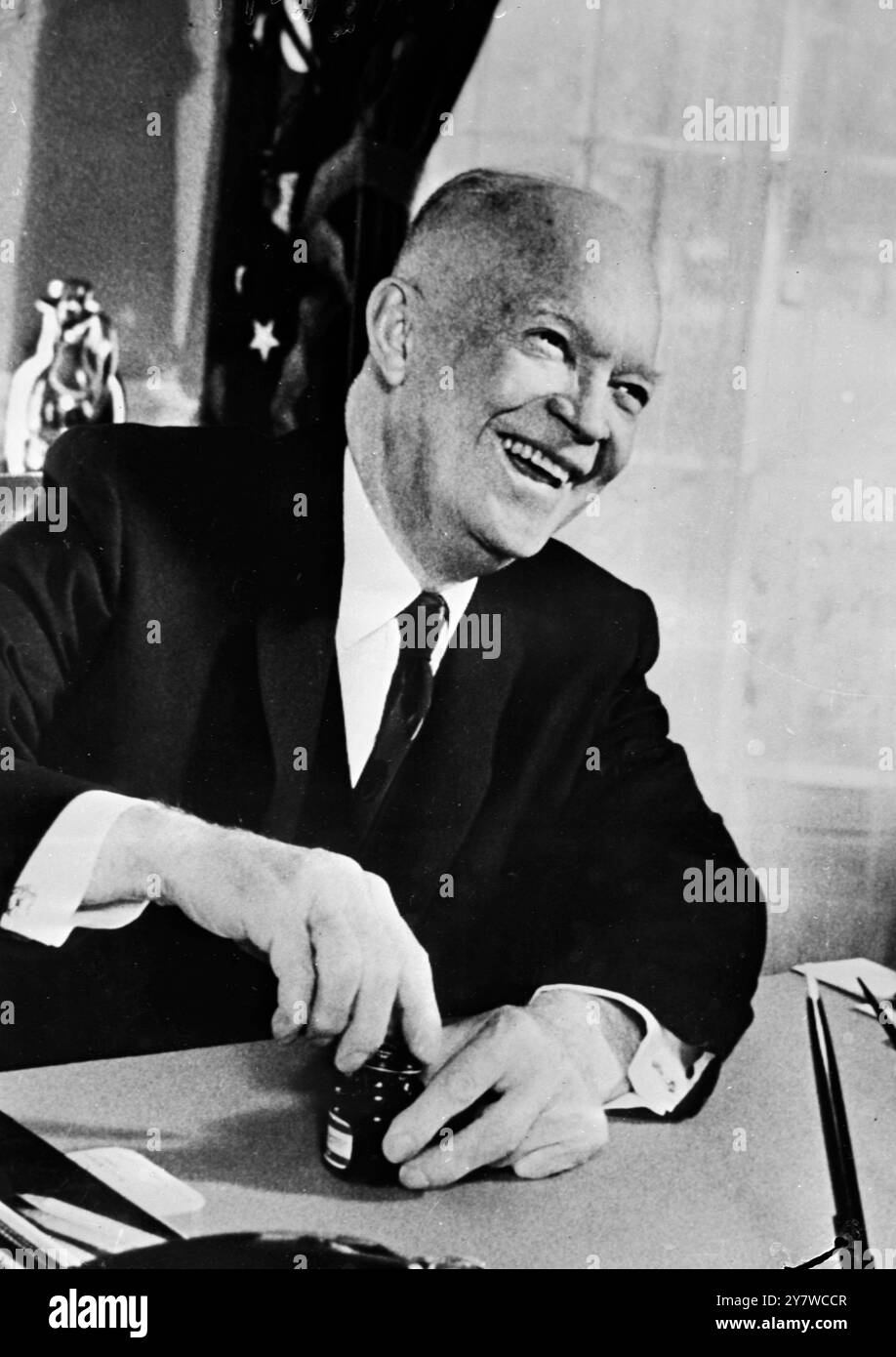President Eisenhower replaces the cap on his ink bottle after signing ...