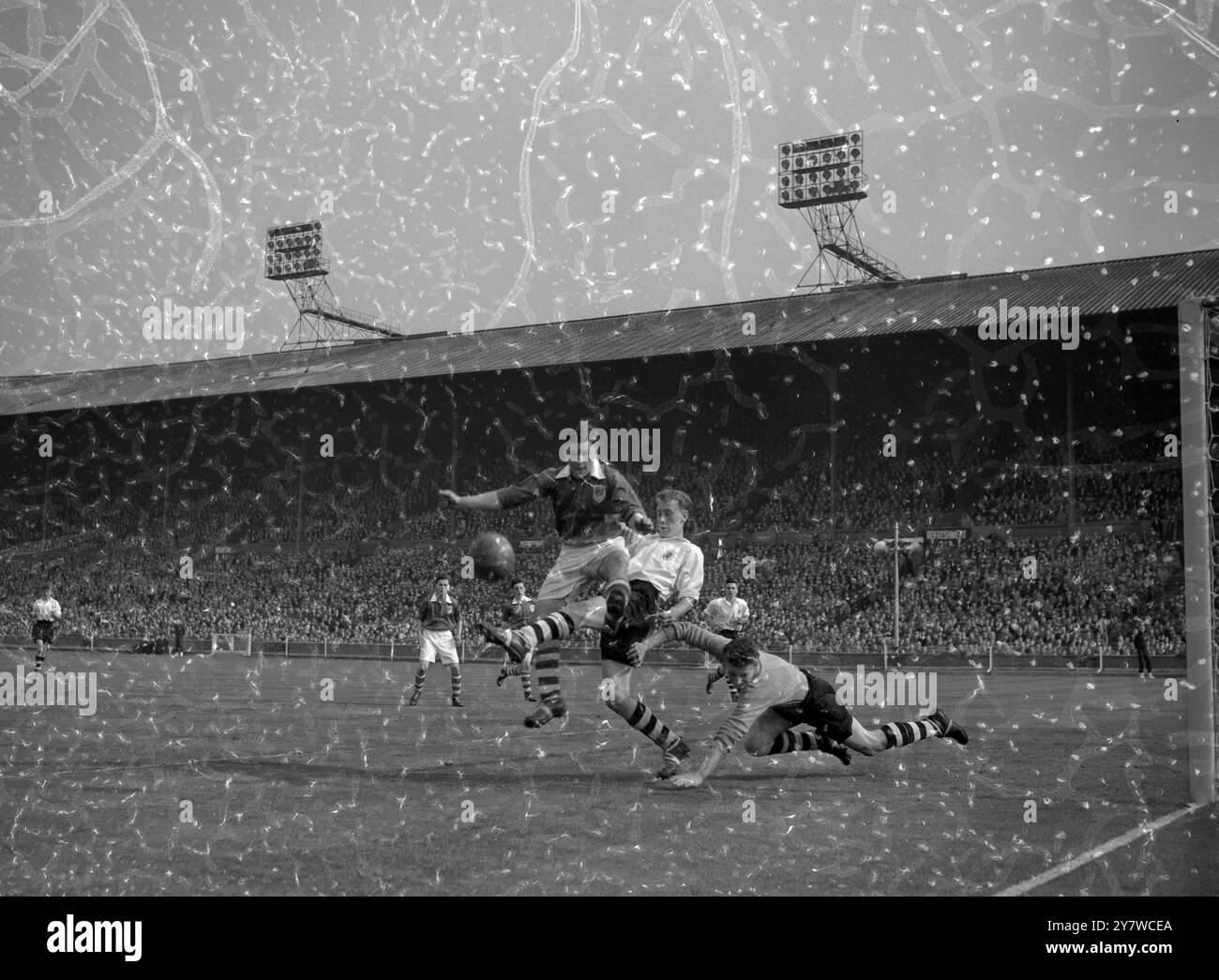 With the English goalkeeper David Gaskell , of Wigan on the turf ...