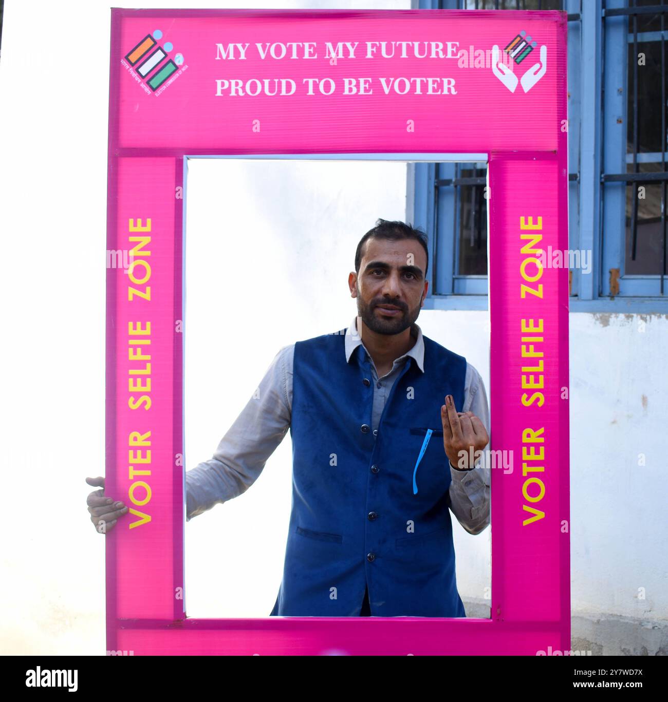 A man stands confidently in the voter selfie frame at Pattan Baramulla ...