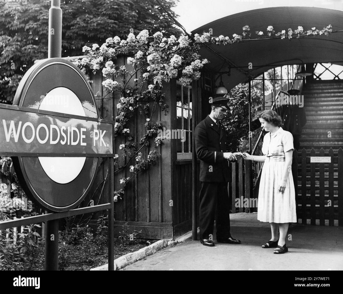 Woodside Park Underground Station showing the lovely archway of roses ...