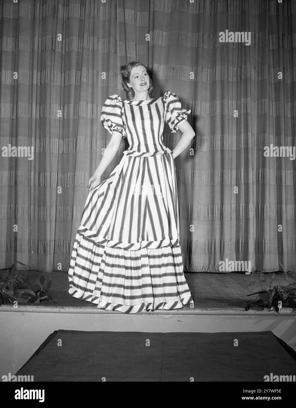 Grace Woods displaying a blue and white striped evening dress of Rosen ...