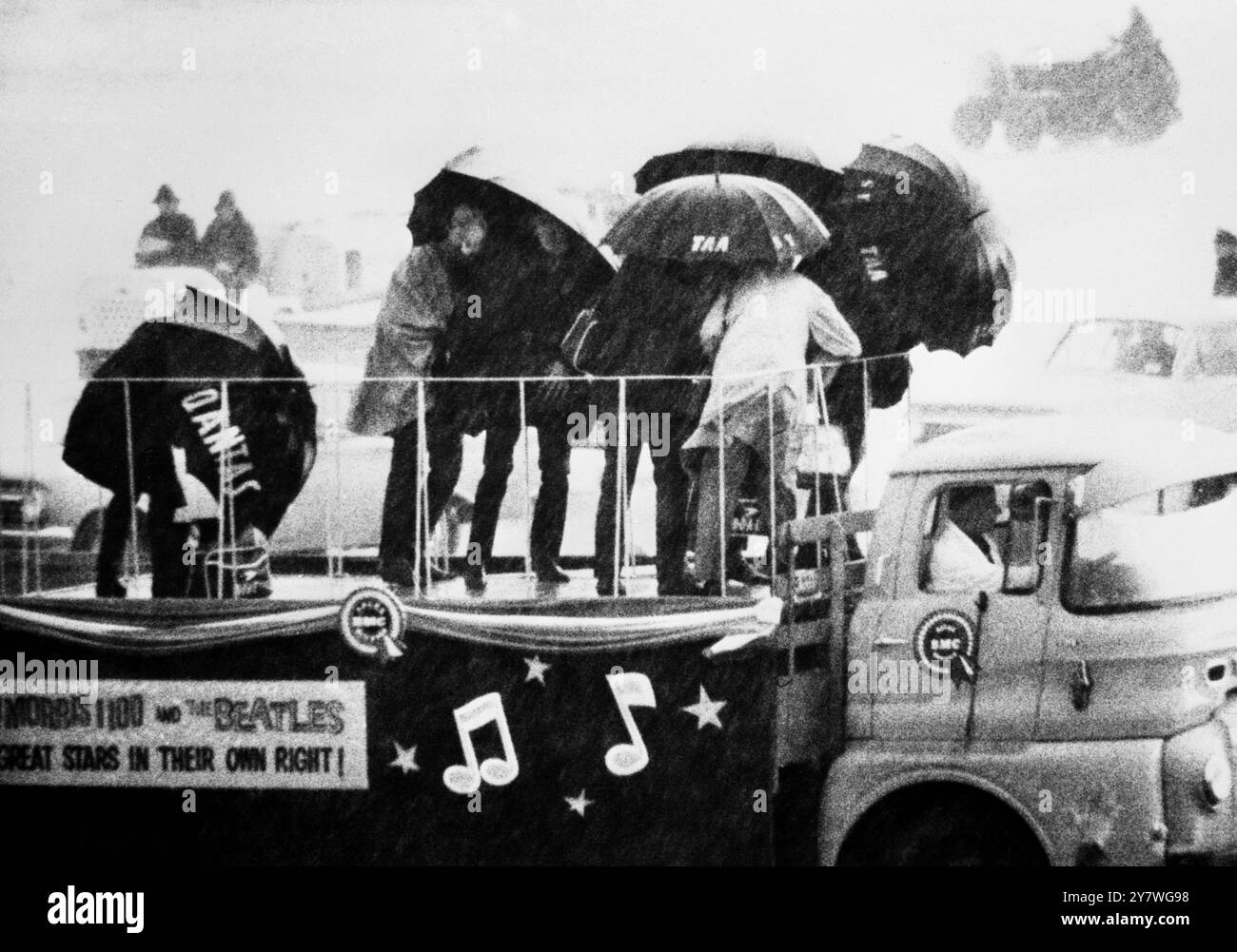 The Beatles , with replacement drummer Jimmy Nicol , sheltering under ...