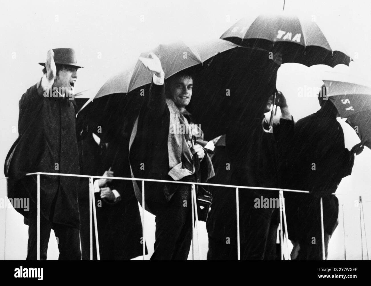 The Beatles , with replacement drummer Jimmy Nicol , sheltering under ...