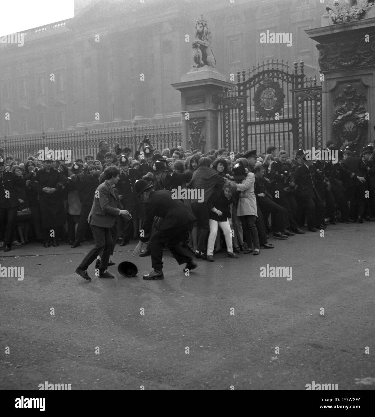 Fans storm Buckingham Palace as the Beatles collect their MBE ' s from ...