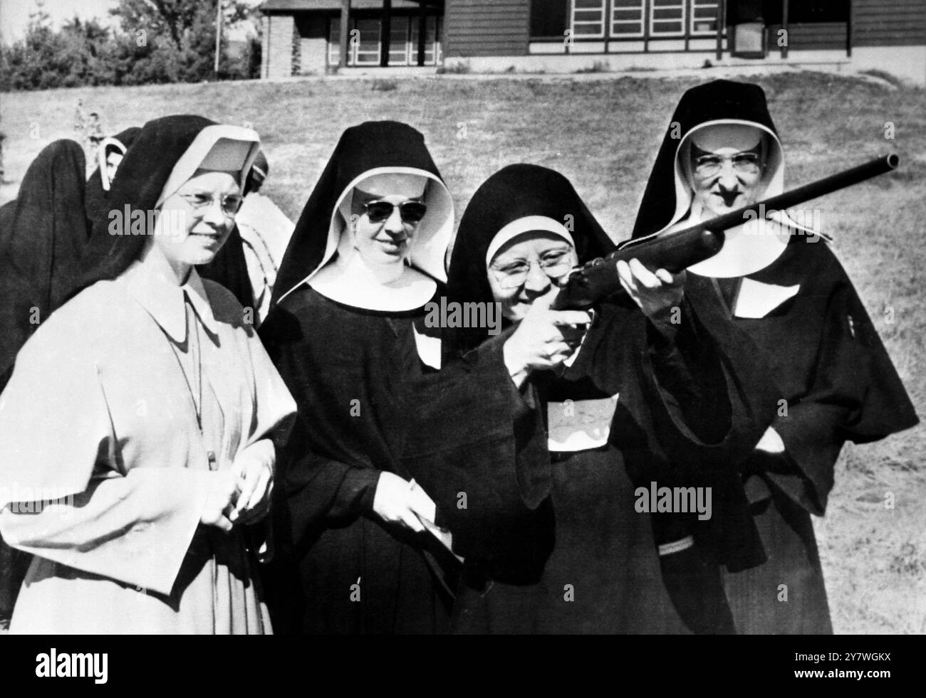 A group of nuns try their hand at target practice during a tour of a ...