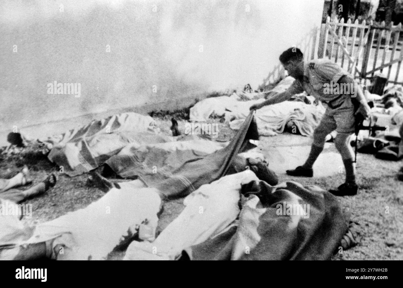 Stanleyville , Congo A soldier checks the covered bodies of European ...