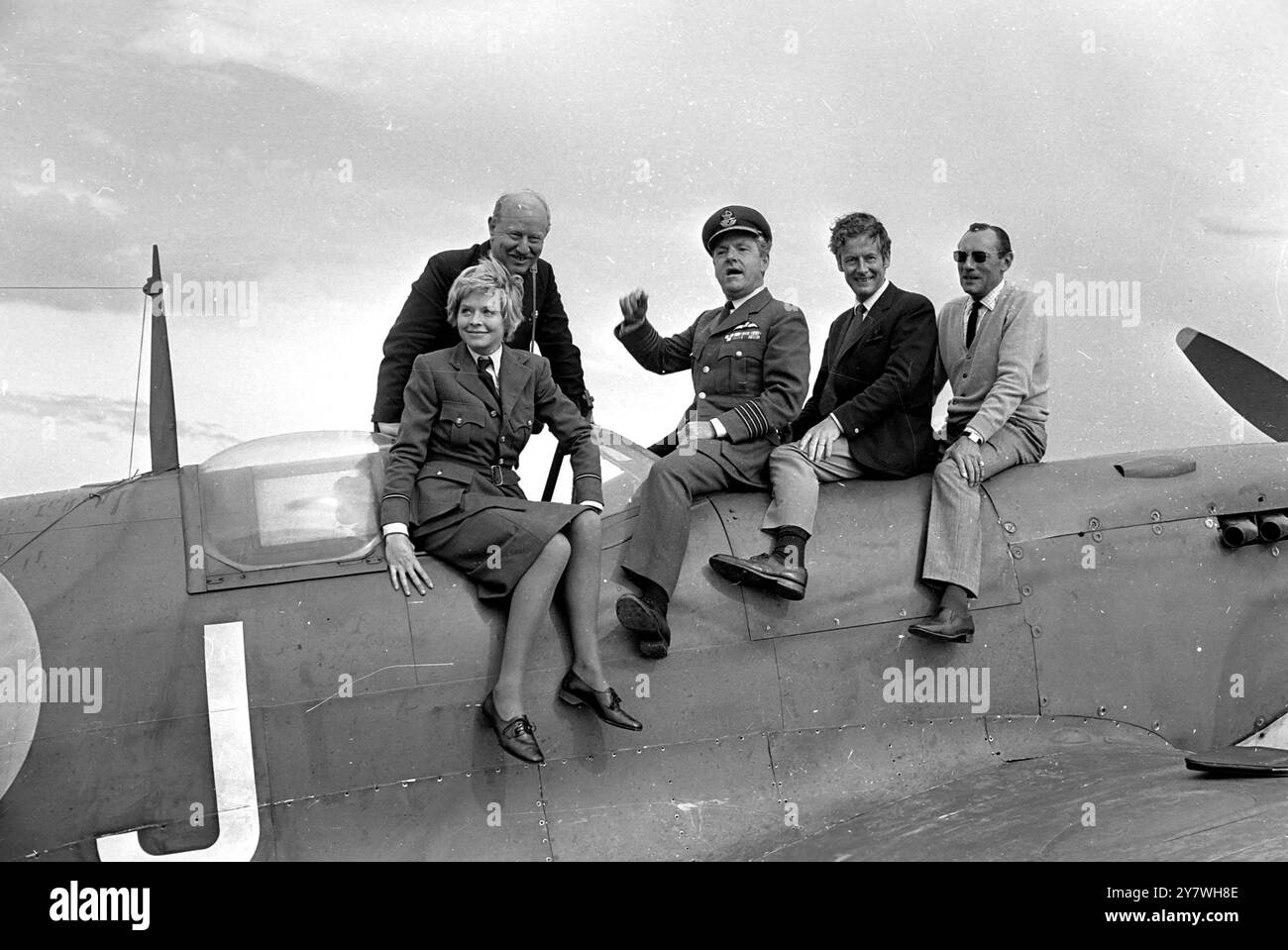 Duxford , Cambridgeshire : Sitting on a Spitfire during filming of ...