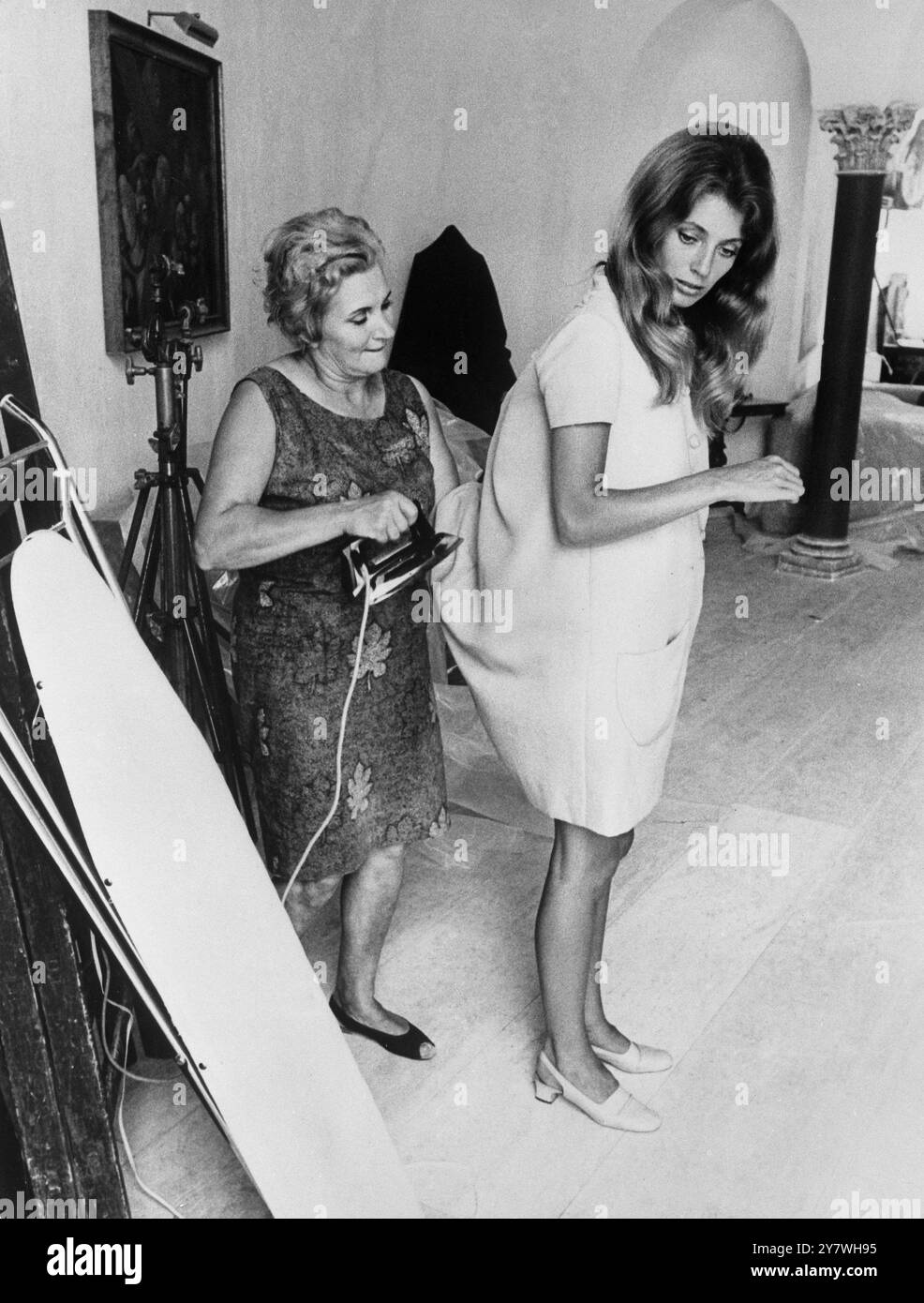 Canadian actress Joanna Shimkus is having her dress ironed between ...