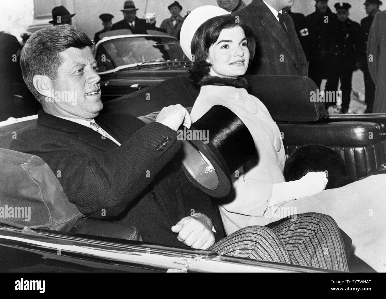 President John Kennedy and his wife Jacqueline sit in their limousine ...