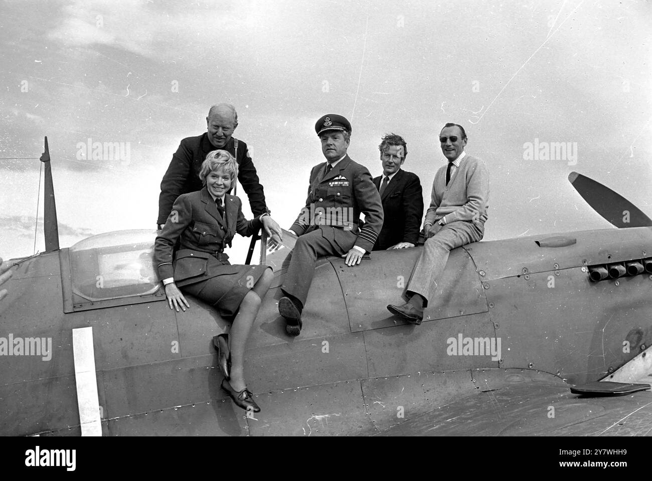 Duxford , Cambridgeshire : Sitting on a Spitfire during filming of ...