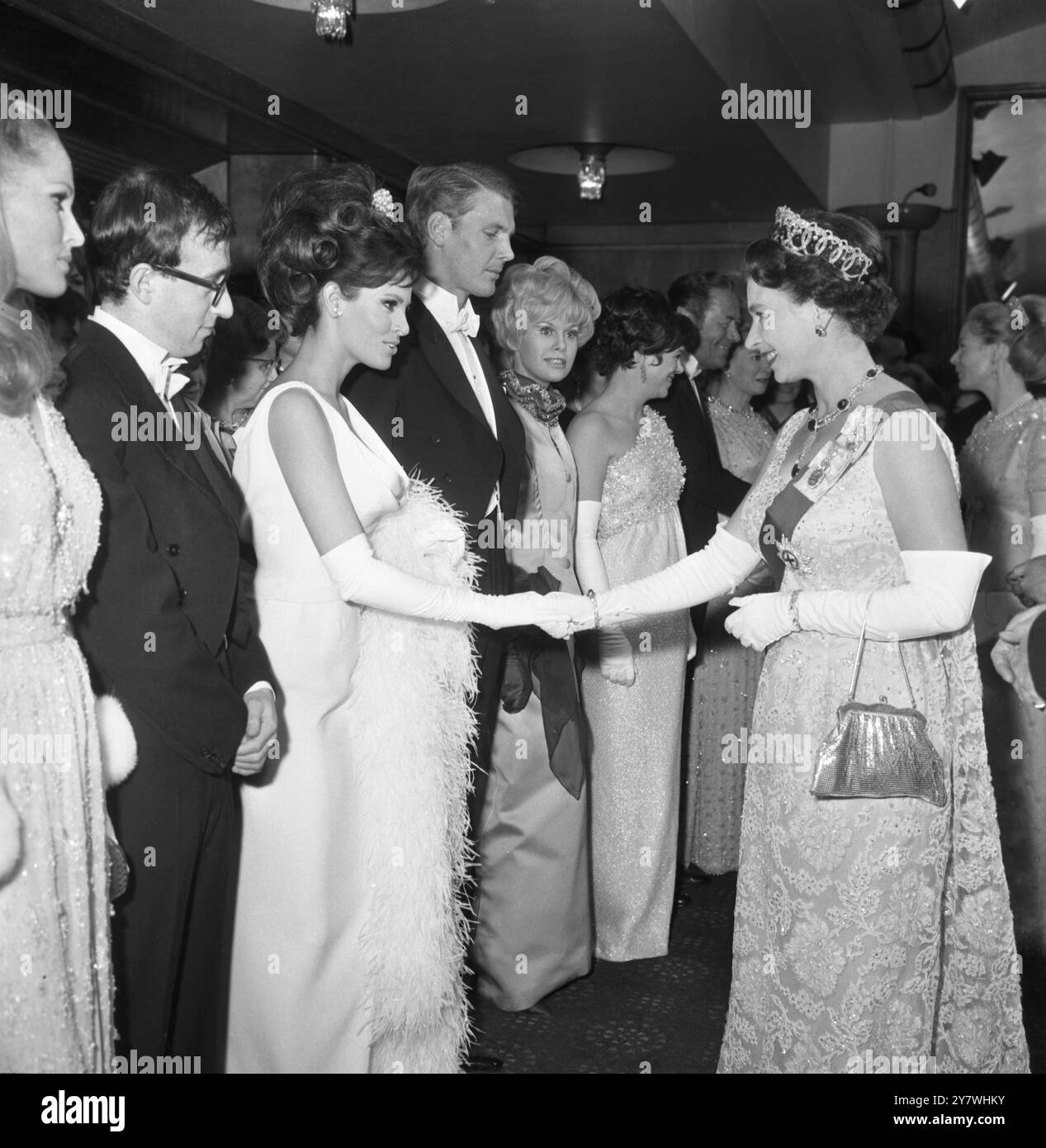 Queen Elizabeth II shaking hands with Raquel Welch before the start of ...