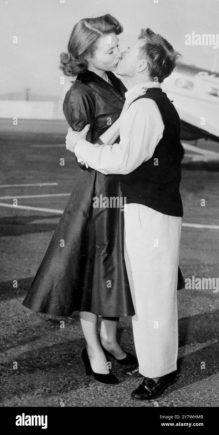 Burbank , California : Film star Mickey Rooney kisses his wife Elaine ...
