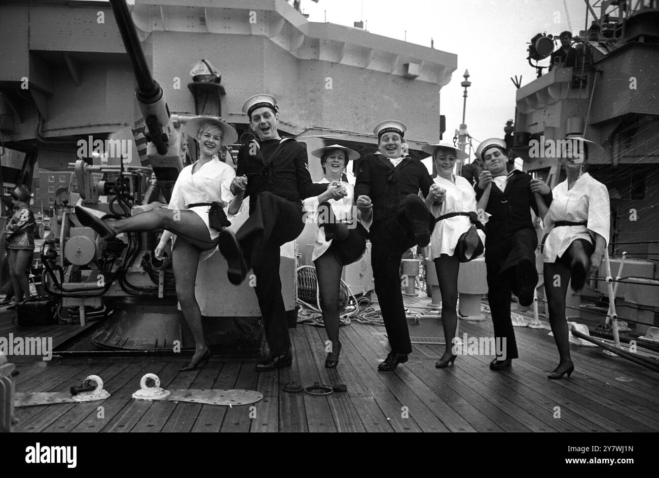 Men and women from the Royal Navy dance in uniform on the HMS Vernon ...