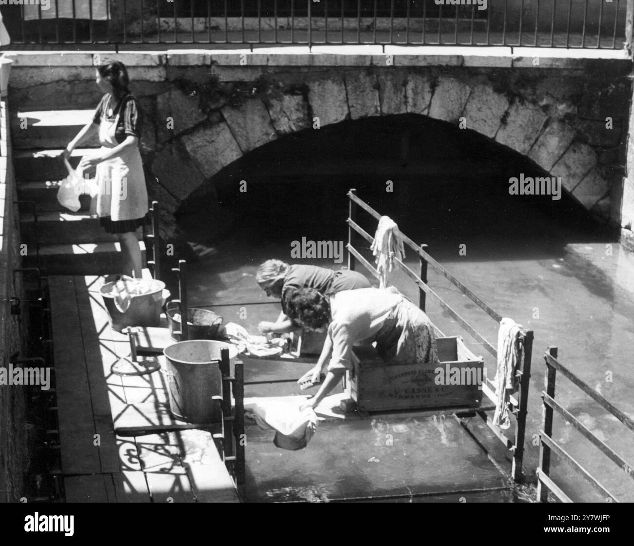 Women washing clothes in Switerland using traditional methods with ...