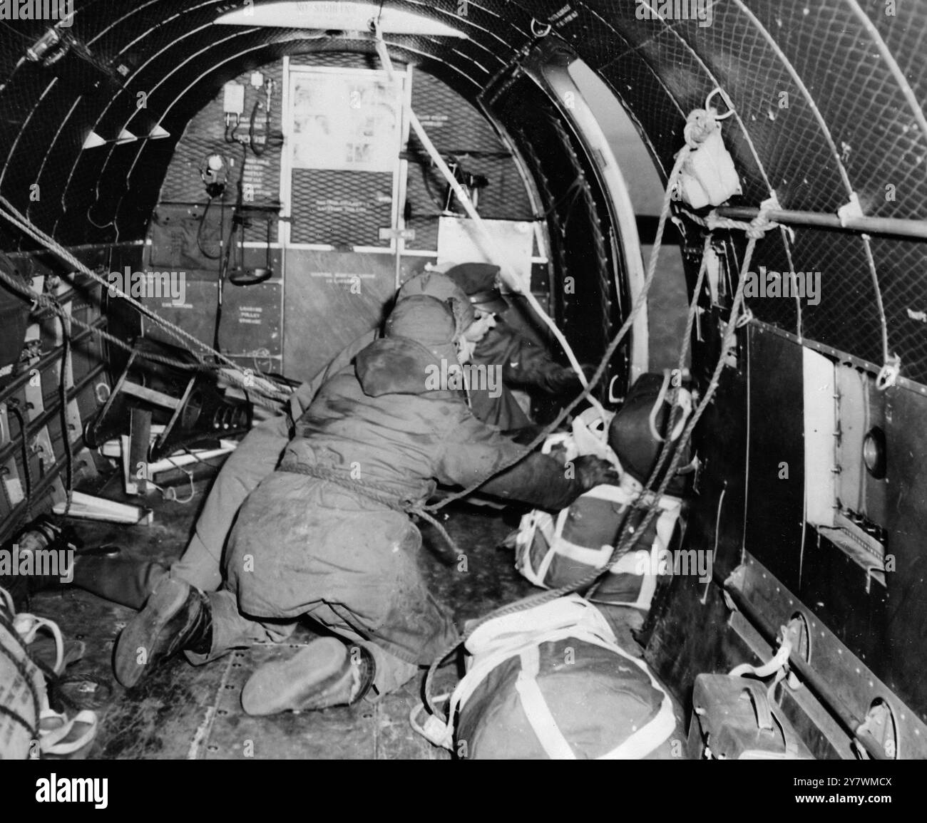 Crew members of a " Santa Claus " plane drop out boxes containing ...