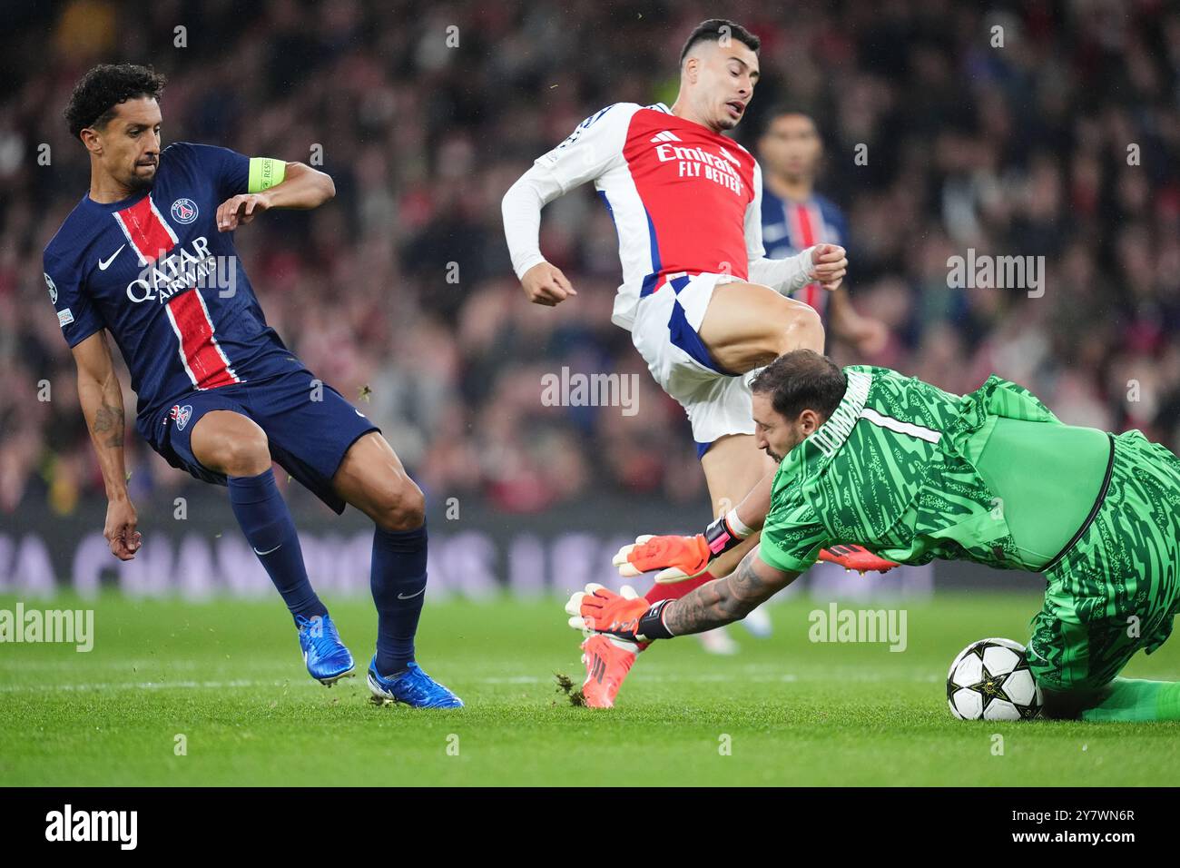Paris Saint Germain goalkeeper Gianluigi Donnarumma (right) saves at ...