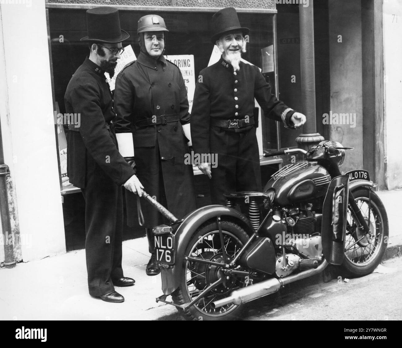 Men dressed in old time police uniforms and a motorcycle. 1954 Stock ...