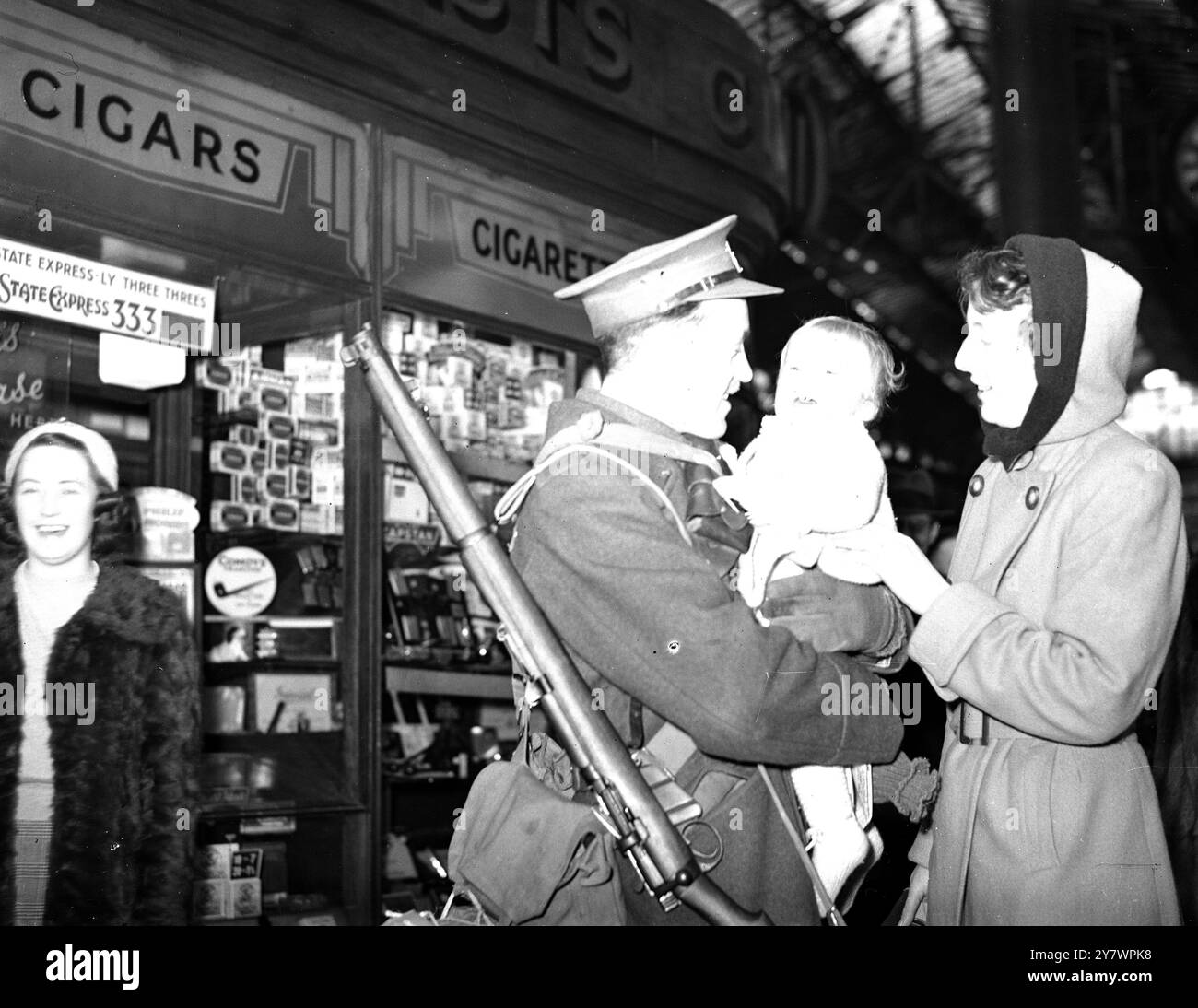 British troop leaves for war , saying goodbye to his wife and child ...
