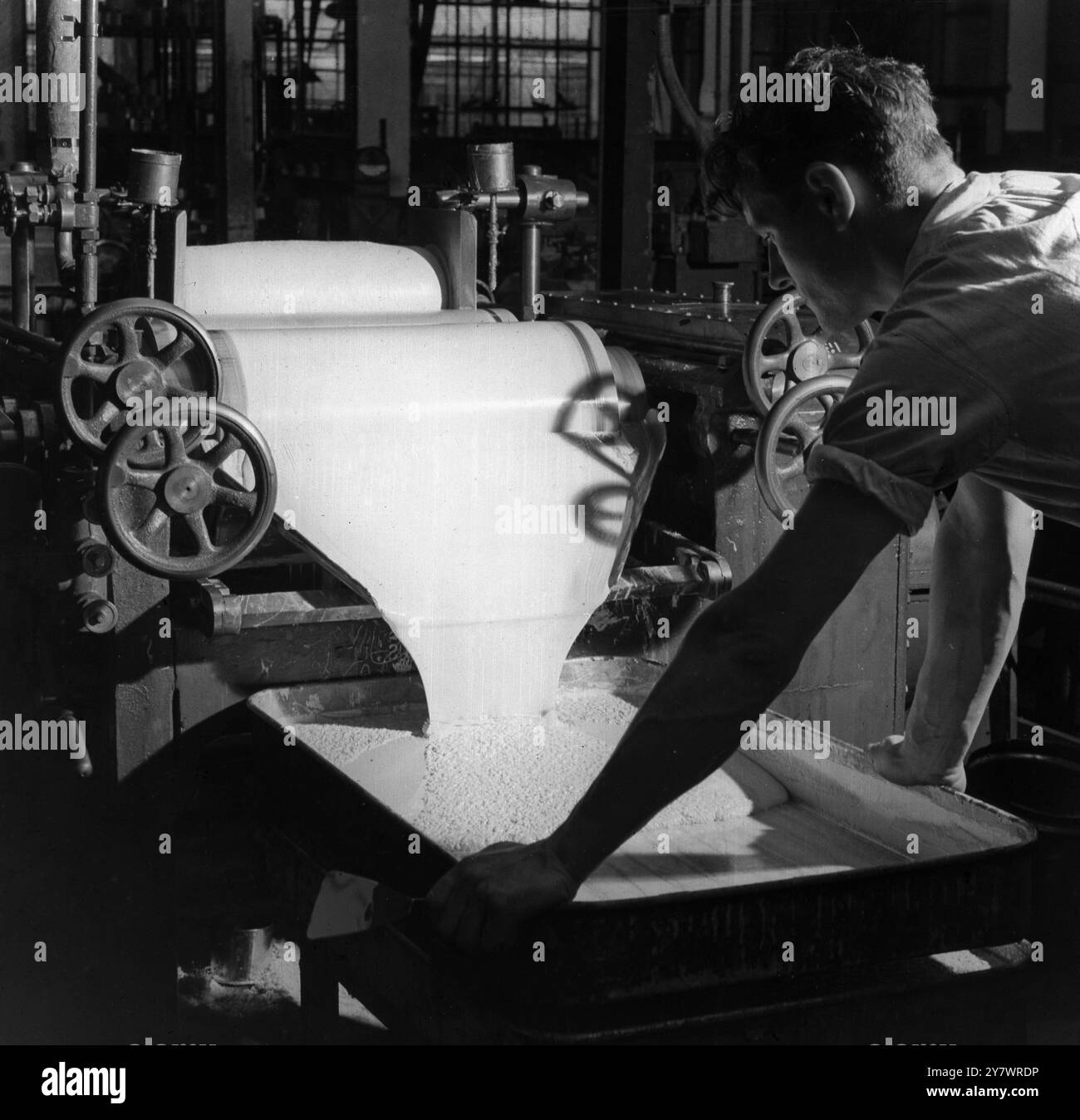 Paint pouring into a container Stock Photo - Alamy