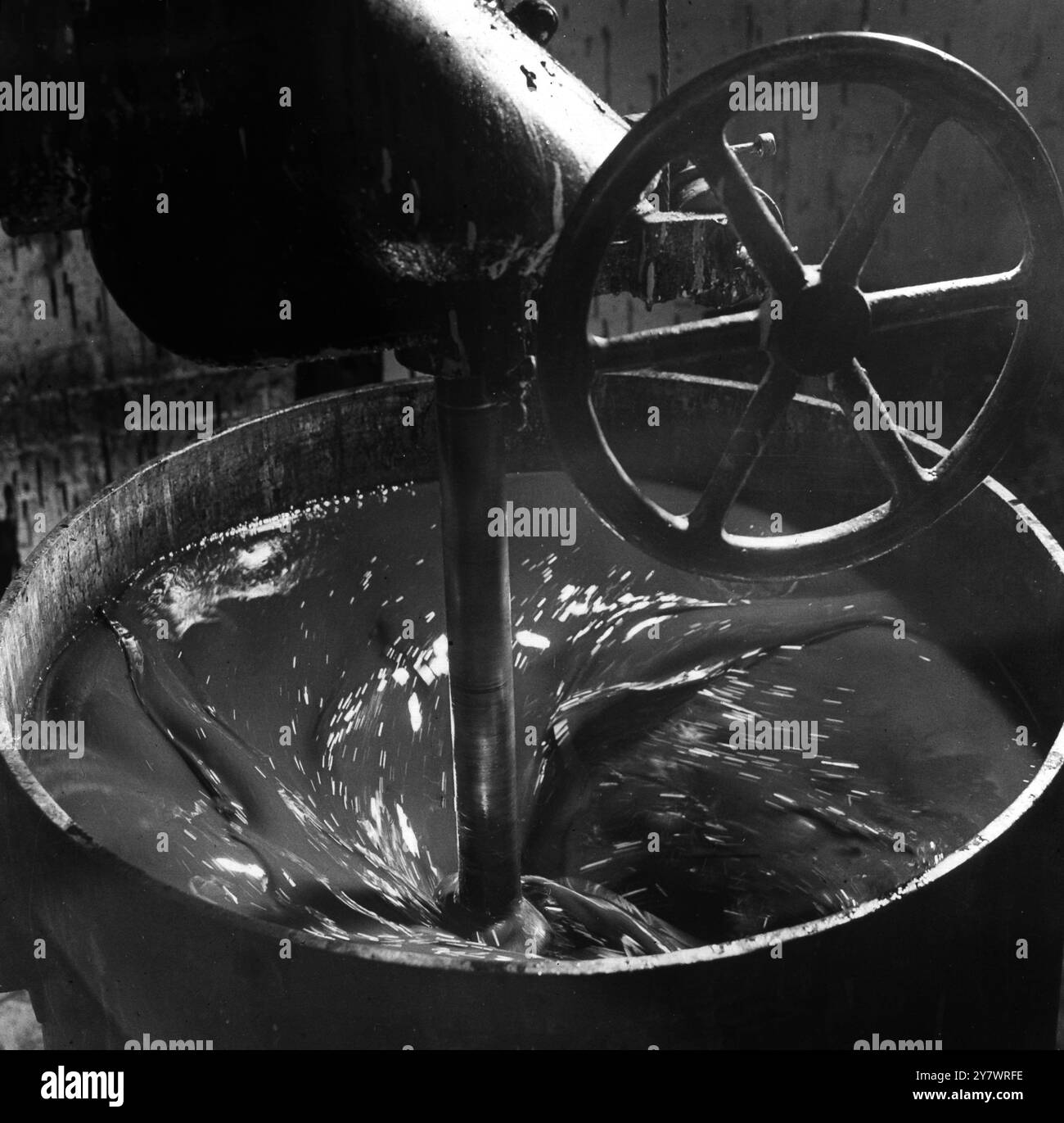 Paint pouring into a container Stock Photo - Alamy