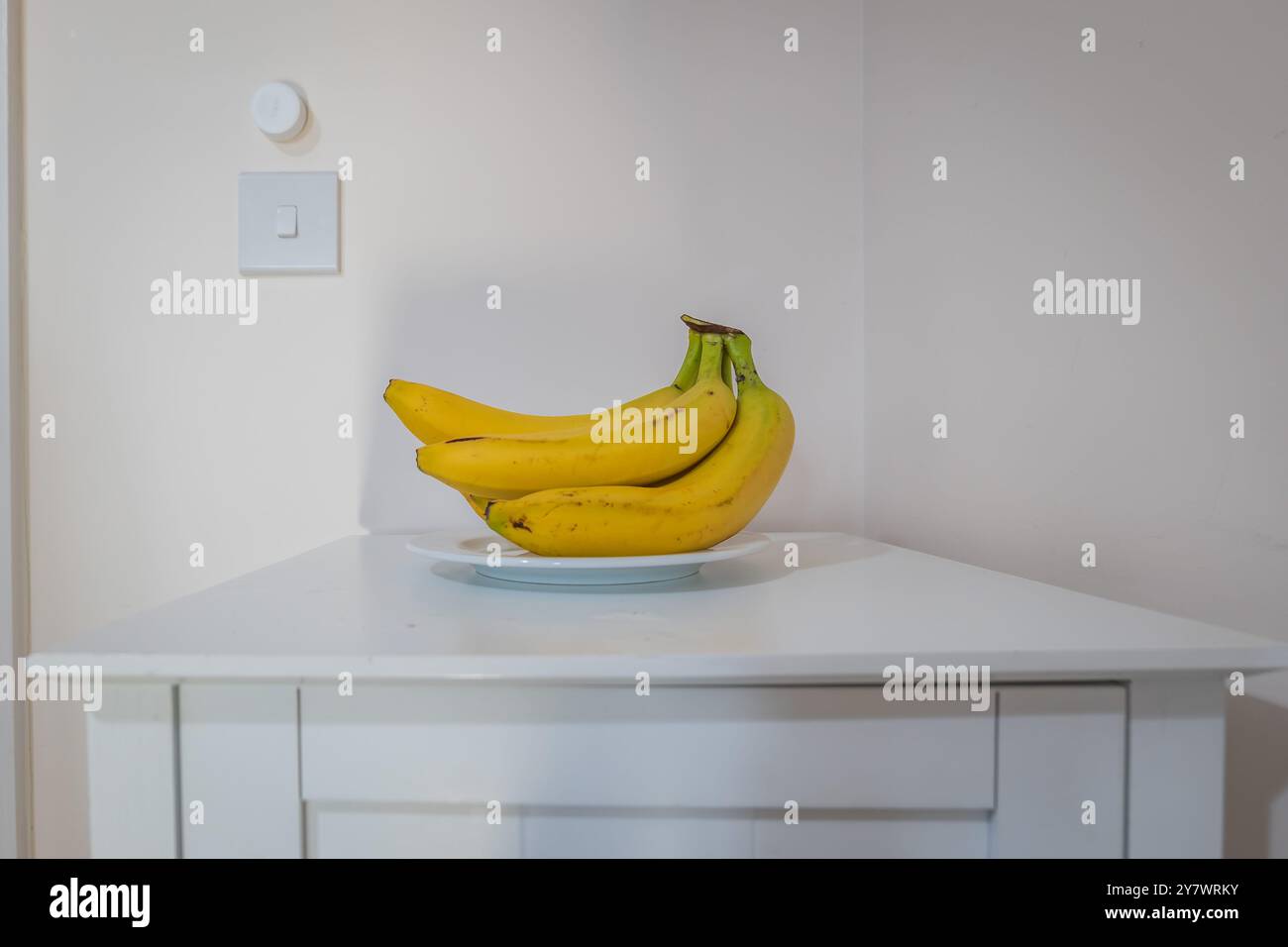 Fresh ripe banana fruit on corner table in hall Stock Photo - Alamy