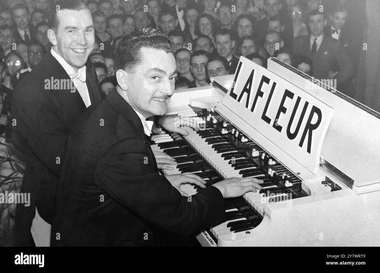 Duet on organ keyboard with audience in the background - LaFleur ...