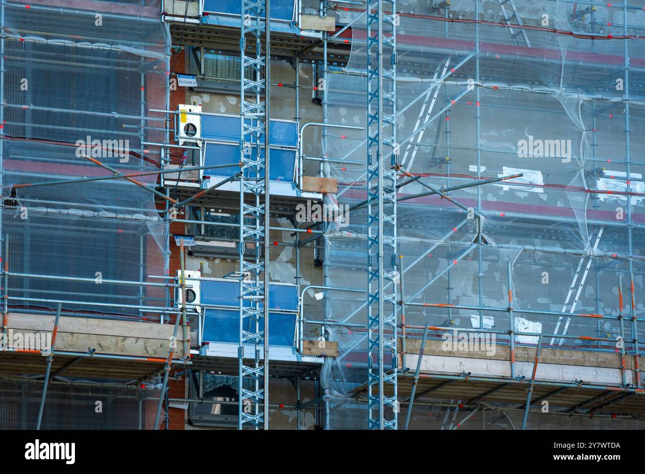 Scaffold sheeting net wrapped apartments building during insulation in ...