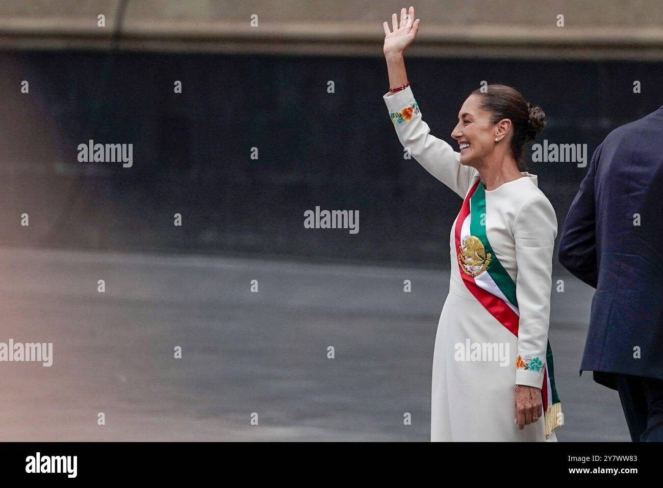 President Claudia Sheinbaum waves upon arrival to the National Palace ...