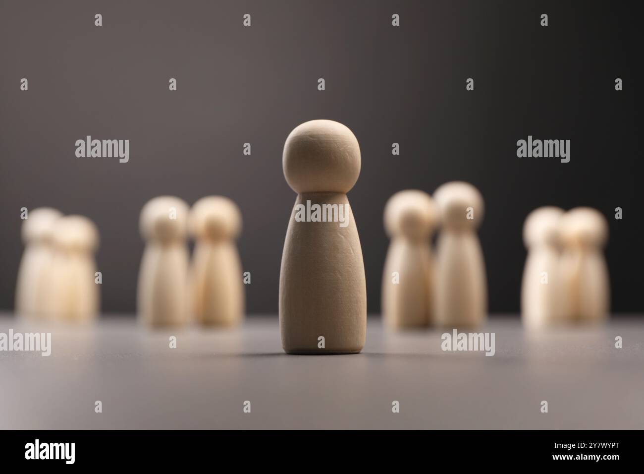 Loneliness concept. Human figure distant from others on grey background ...