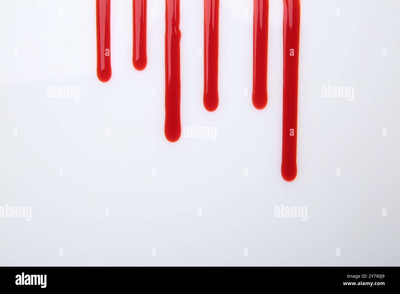 Leaking red blood stain on white background Stock Photo - Alamy