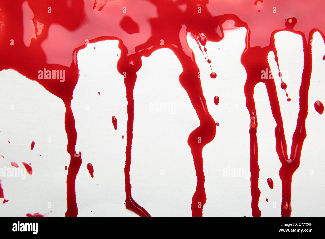 Leaking red blood stain on white background Stock Photo - Alamy