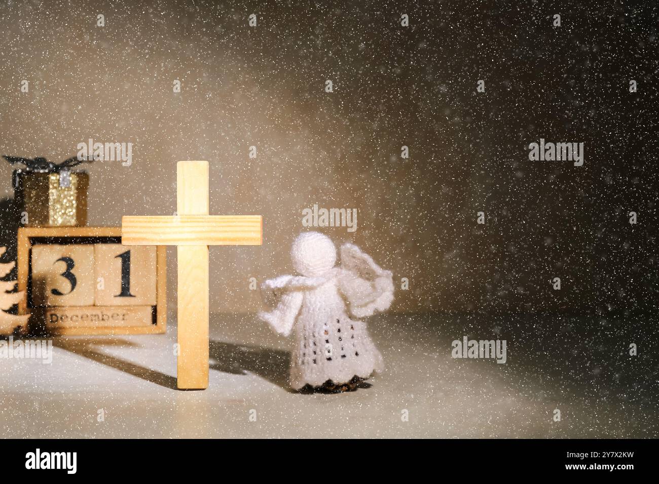 Cross, calendar and angel on table. Concept of Christmas story Stock ...