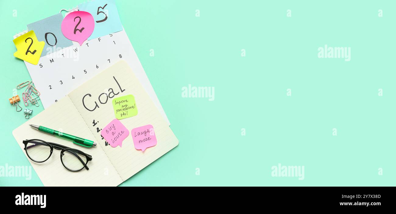 Notebook with to do list and calendar on turquoise background with ...