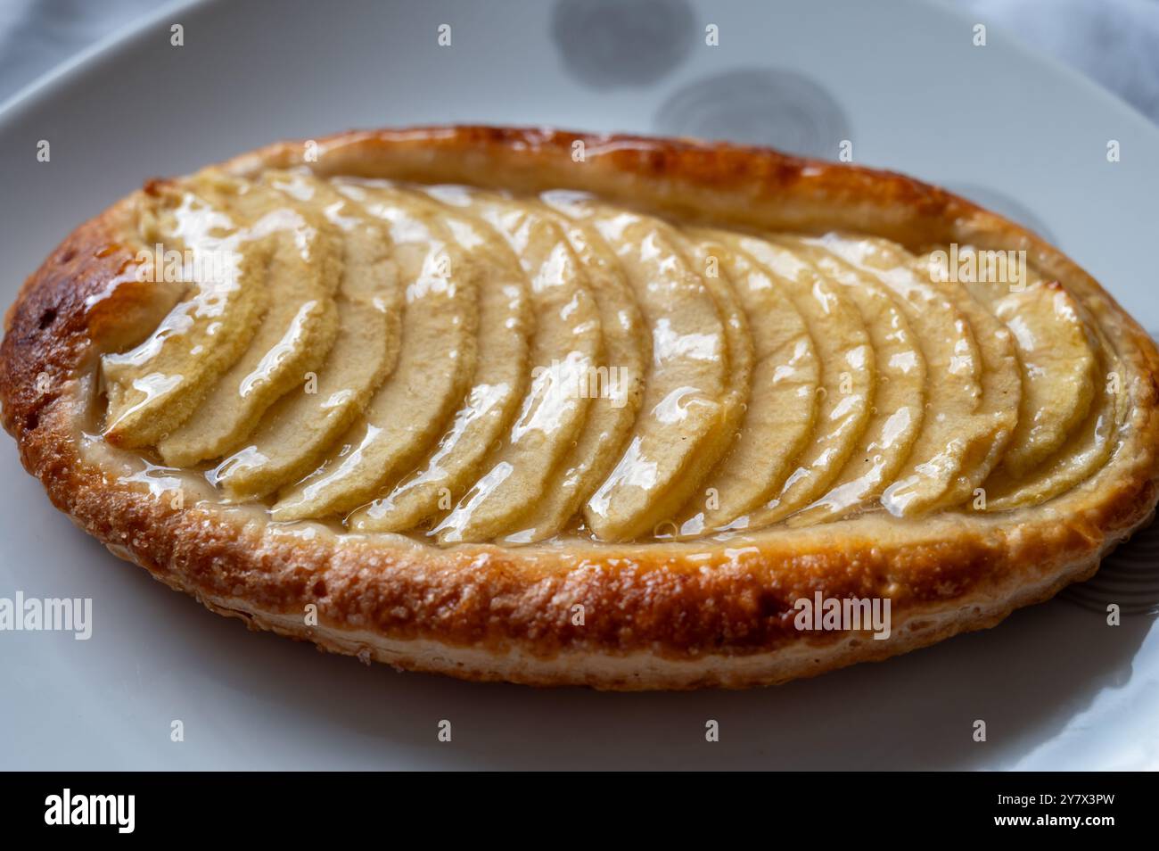 French fresh baked sweet puff pastry with fresh apple fruits in sirup ...
