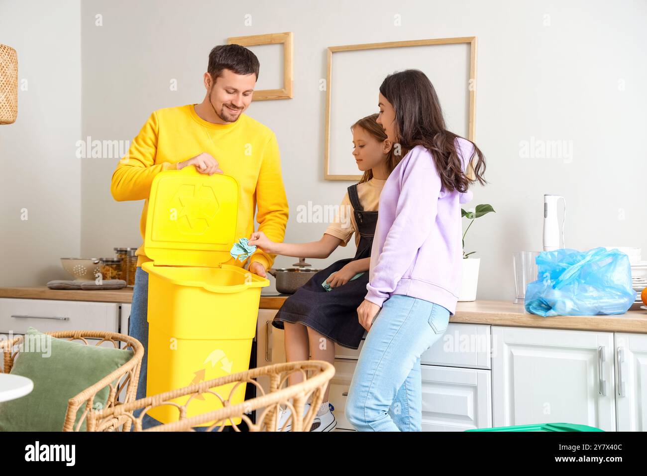 Family throwing paper garbage in recycle bin at home Stock Photo - Alamy