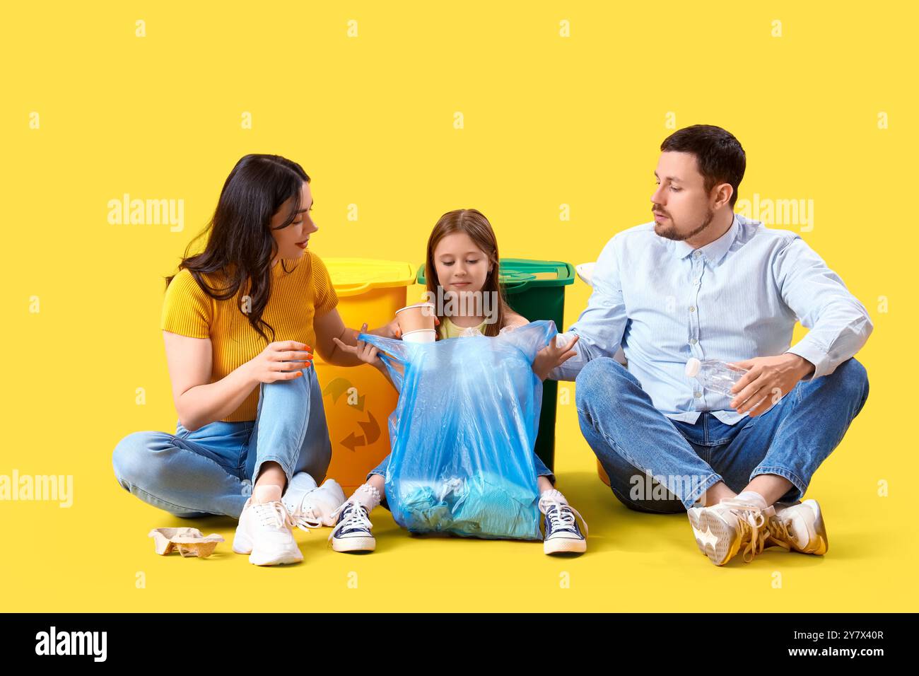 Family with garbage bag and recycle bins on yellow background Stock ...