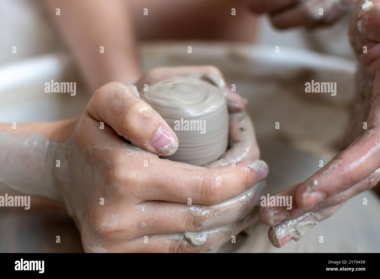Making of mud pot on potters wheel during workshop in design modern art ...