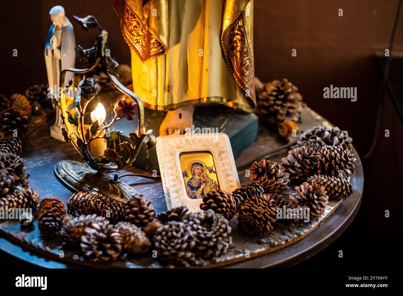 A small Catholic icon surrounded by pine cones Stock Photo - Alamy