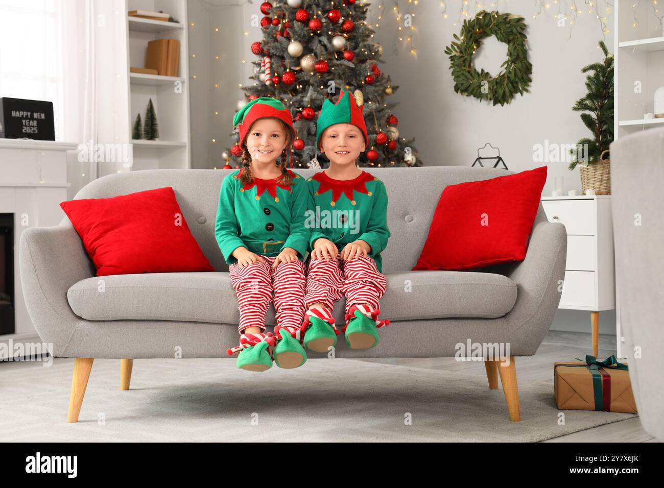 Cute little children in elf costumes at home on Christmas eve Stock ...