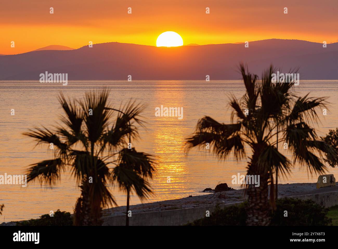 Sunset behind the Turkish coast at Tigaki (Tingaki) beach on the island ...